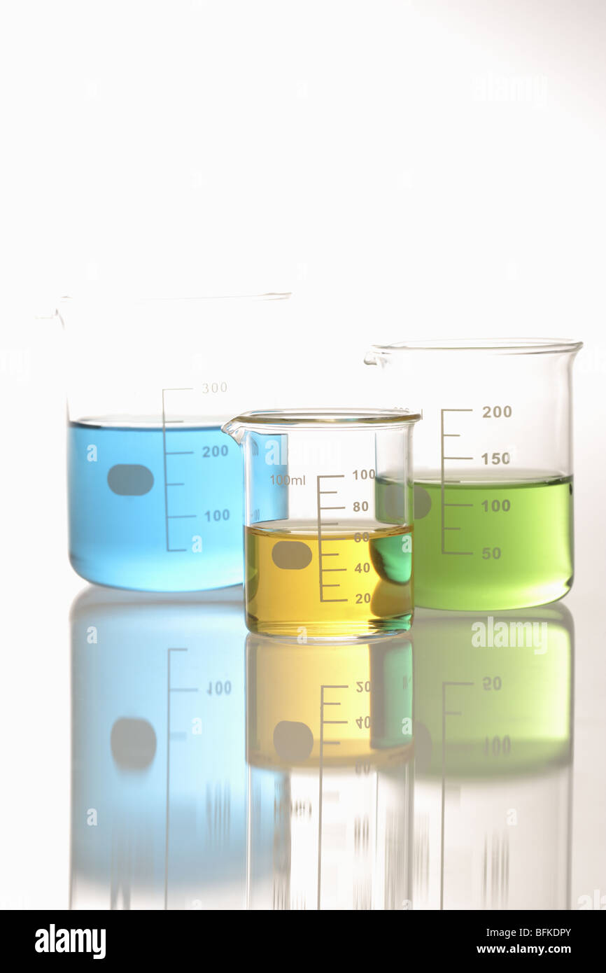 Colorful liquids in beaker white background Stock Photo - Alamy