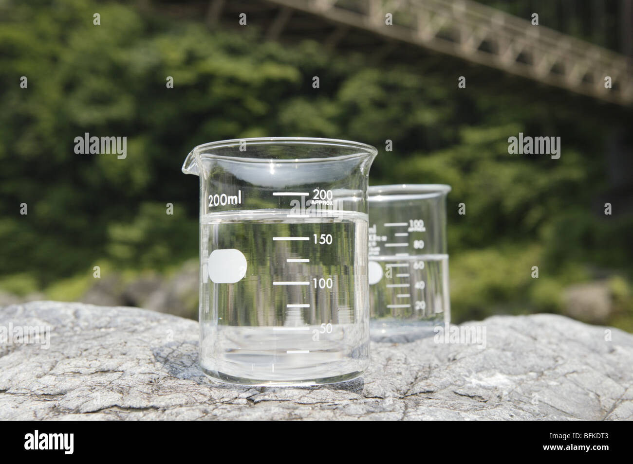 Beakers on rock Stock Photo - Alamy