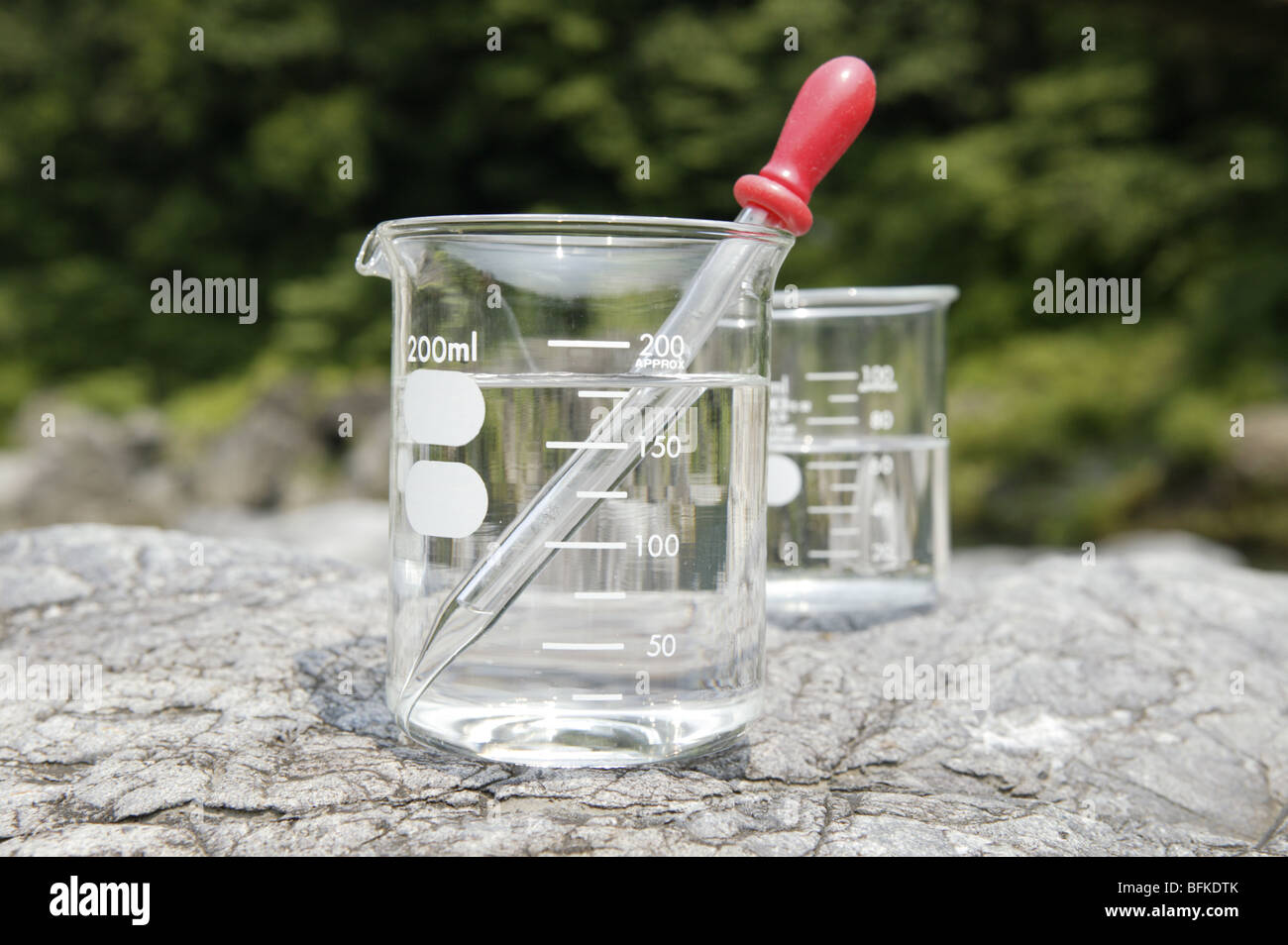 Beakers on rock Stock Photo - Alamy