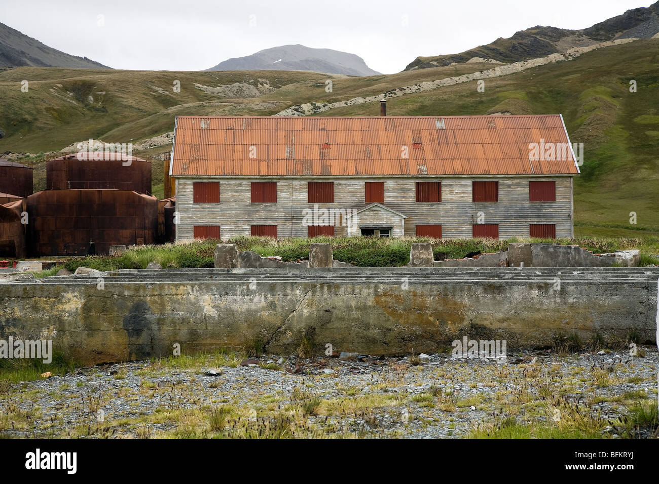 Old dormitory building next to oil storage tanks, Grytviken, South ...