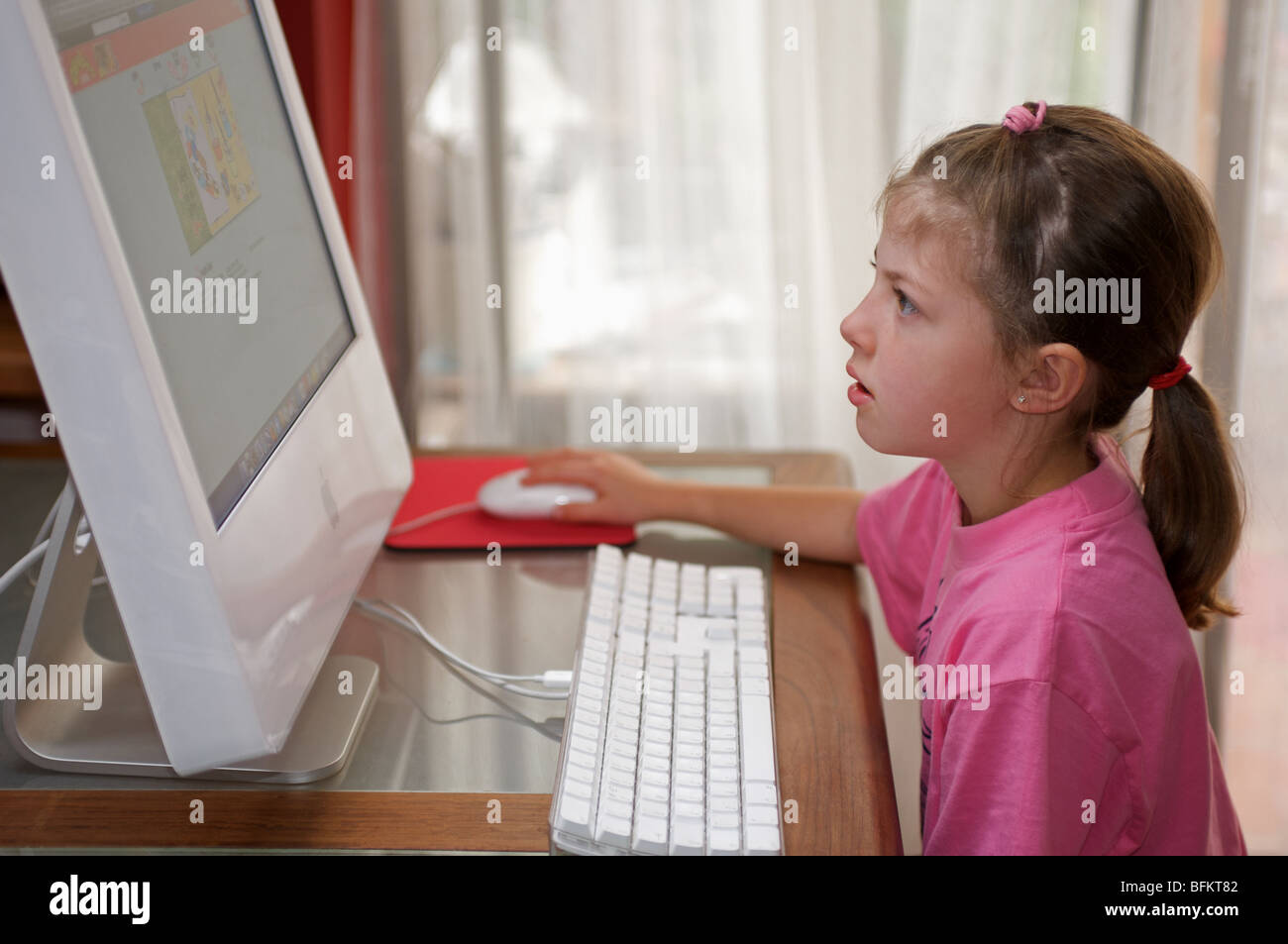 6-year old girl using a computer to access the BBC's CBeebies ...