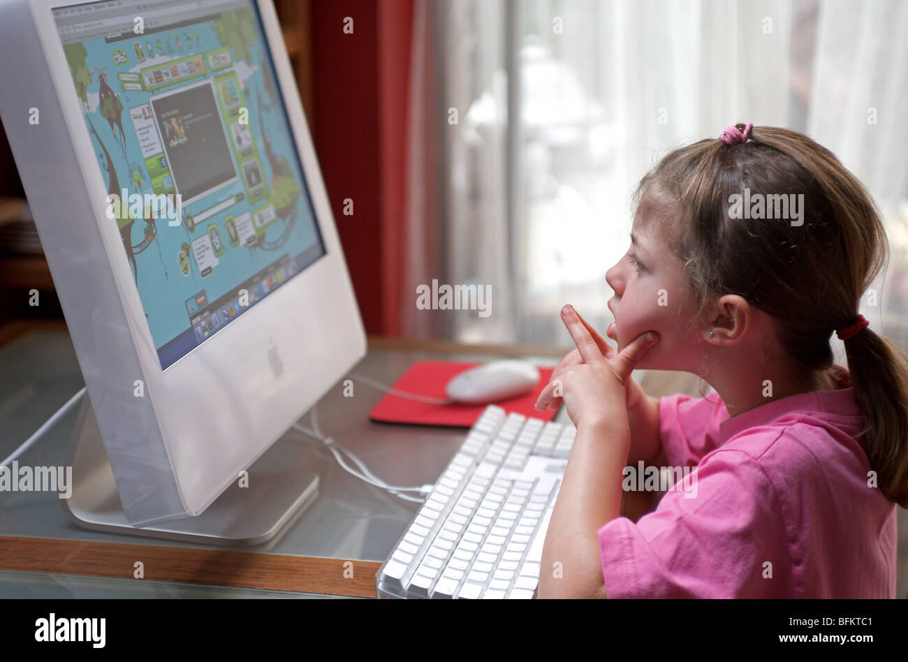 6-year old girl using a computer to access the BBC's CBeebies ...