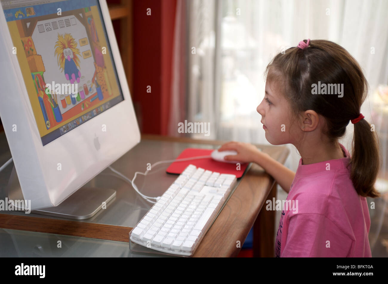 6-year old girl using a computer to access BBC online games Stock Photo ...