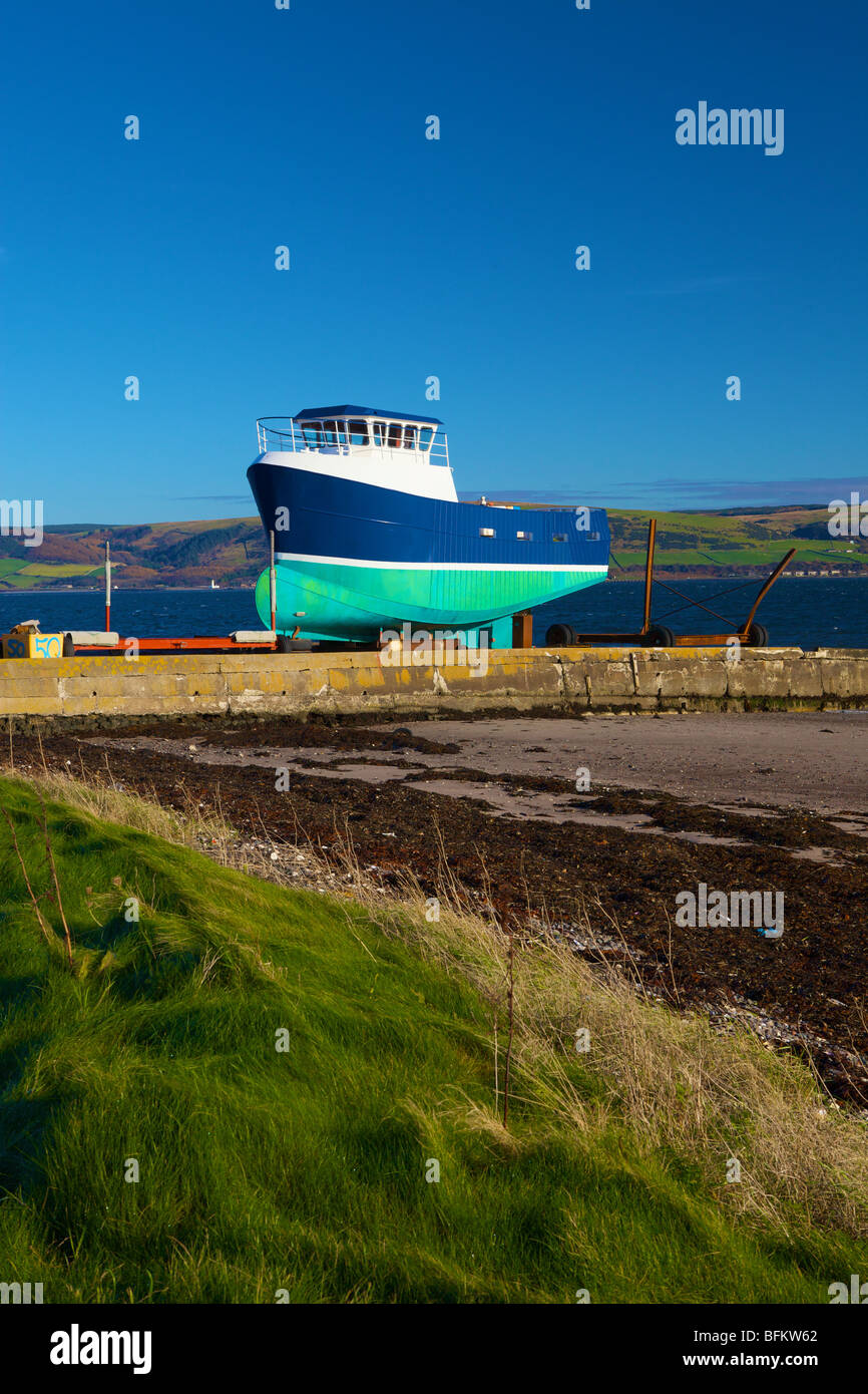 A new fishing boat being built, freshly painted, being worked on ...