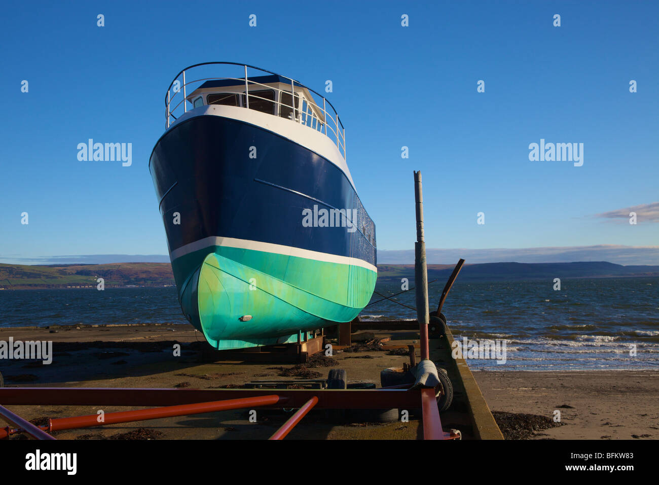 A new fishing boat being built, freshly painted, being worked on ...