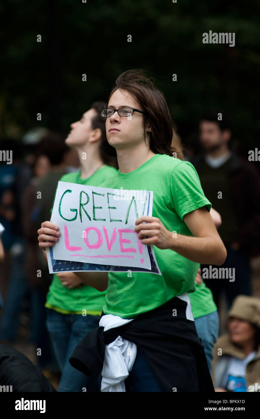 An environmental activist holds a sign saying, "Green Love" during the ...