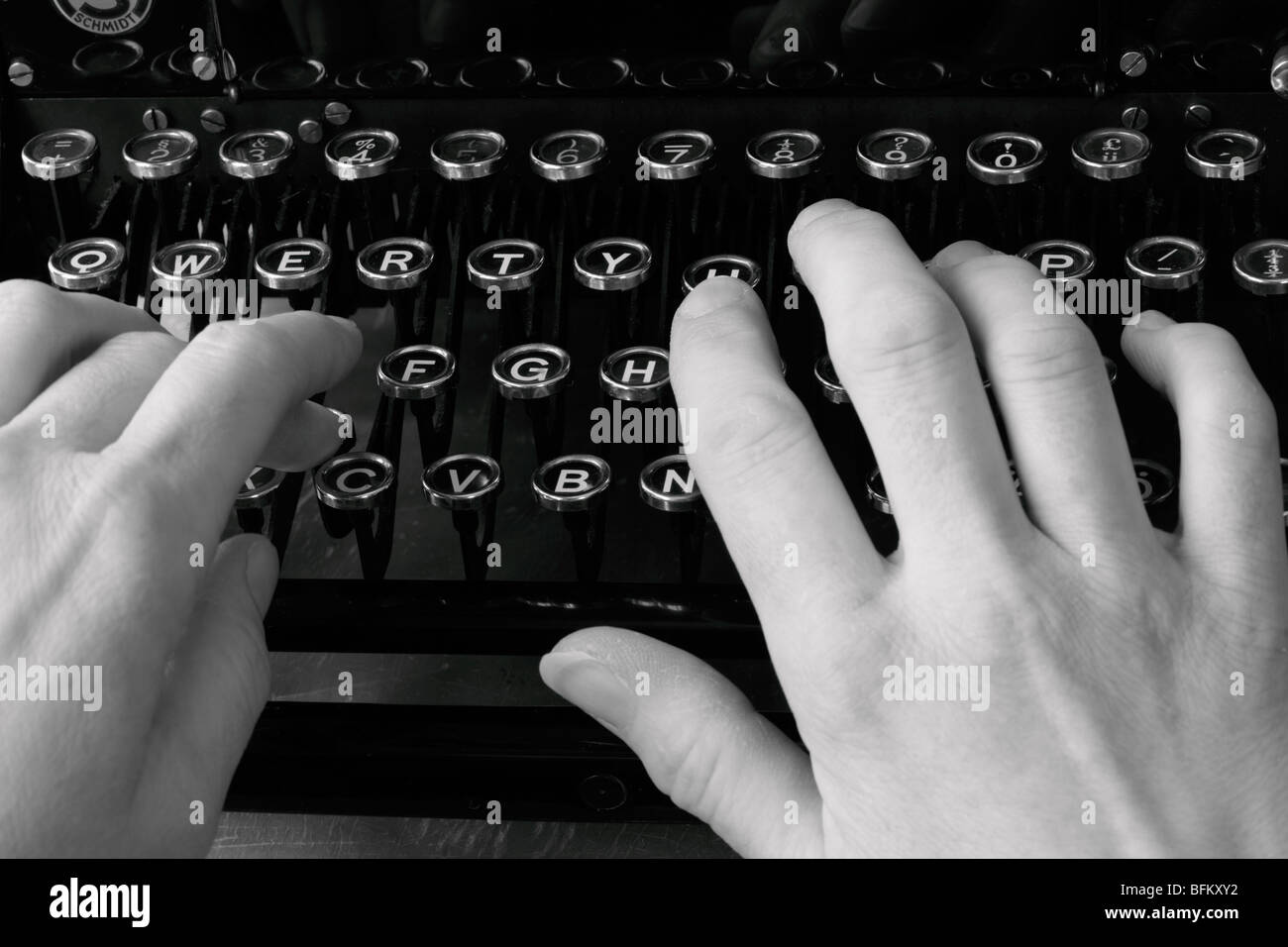 A woman's hand typing on an old fashioned typewriter from the thirties ...
