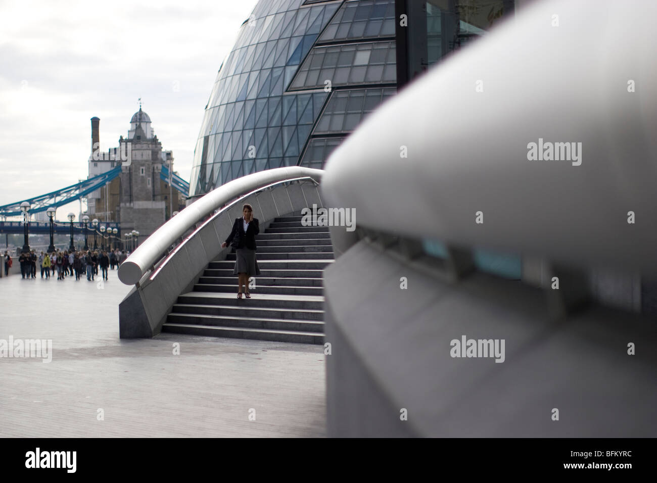 Pedestrians make their way along Queens Walk beside the River Thames ...