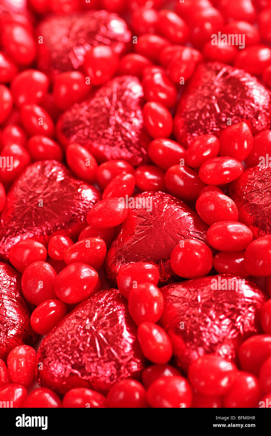 Background of red Valentine's candies and foil wrapped chocolates Stock ...