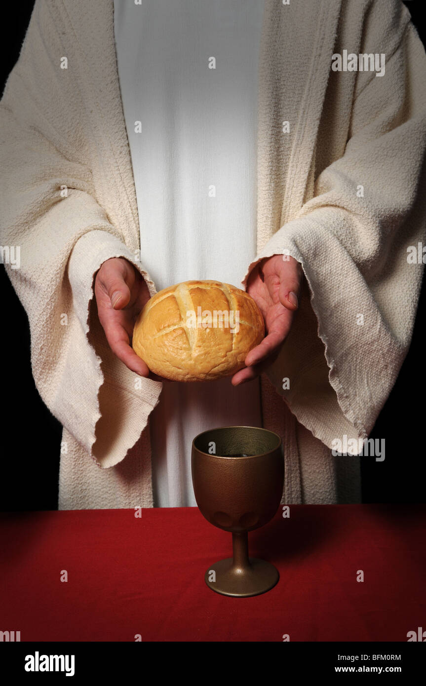 Jesus hands holding the bread at the Communion table Stock Photo - Alamy