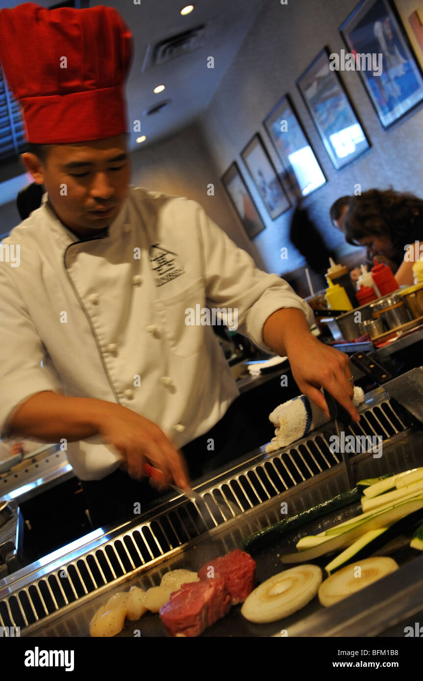 Chef cooking food on a grill at Japanese restaurant Stock Photo - Alamy