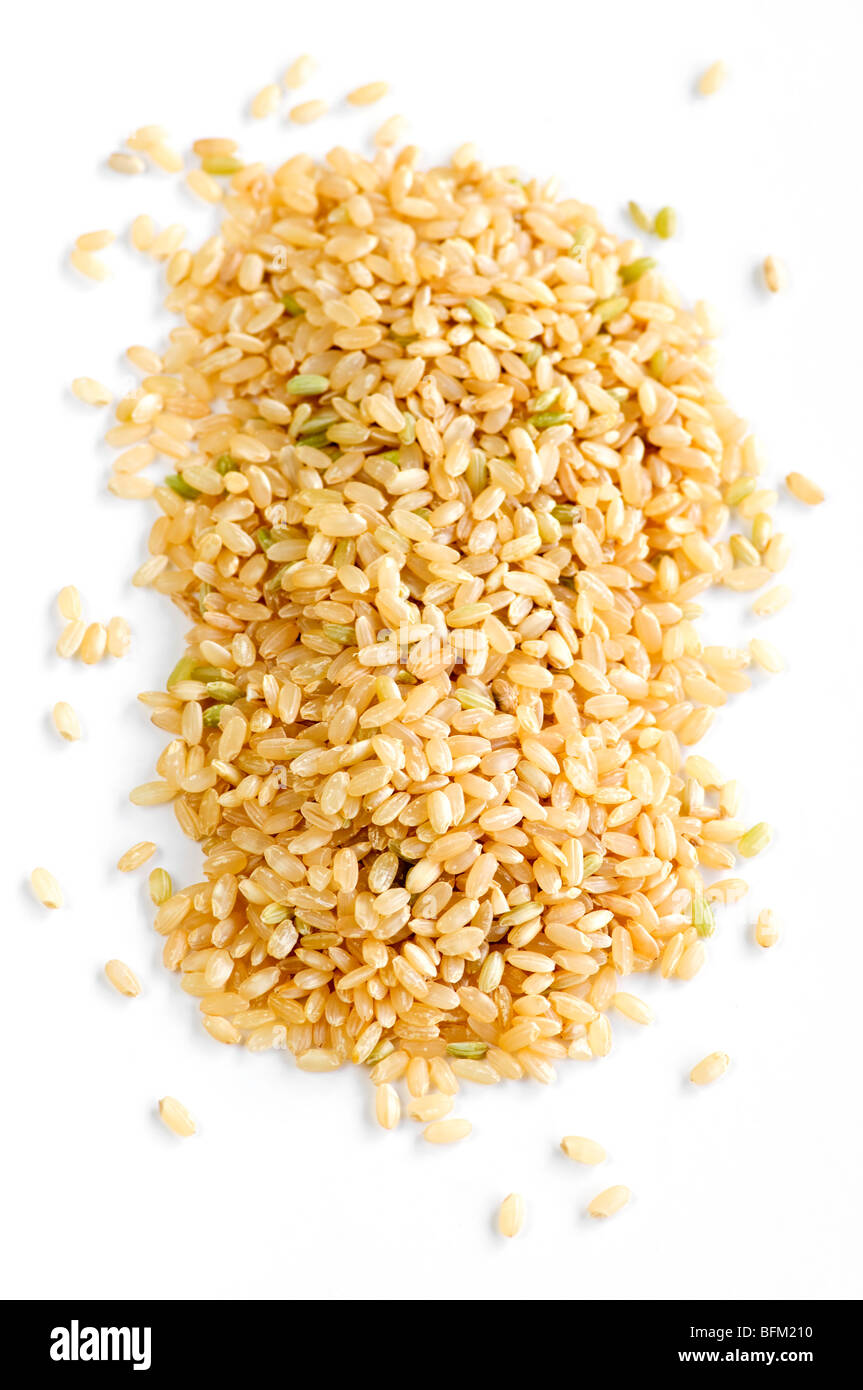 Pile of short brown rice grains isolated on white background Stock ...
