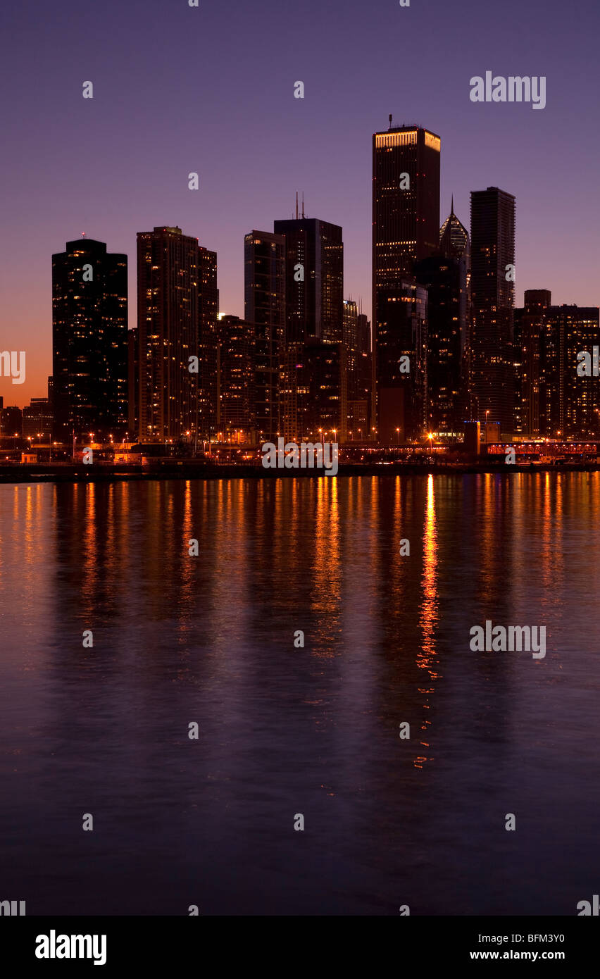 Chicago city skyline reflected in Lake Michigan at twilight after ...