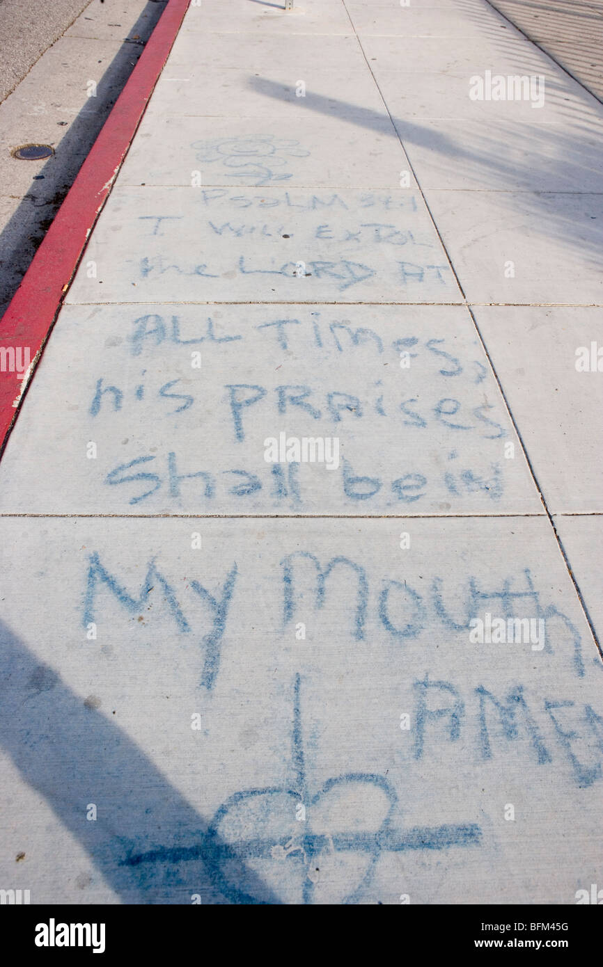 Christian graffiti written with spray paint on a sidewalk, Los Angeles ...
