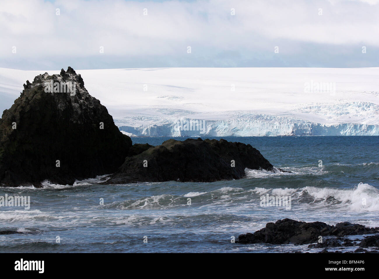 Jagged rocks and ice cap near Arctowski Polish Station, Antarctica ...
