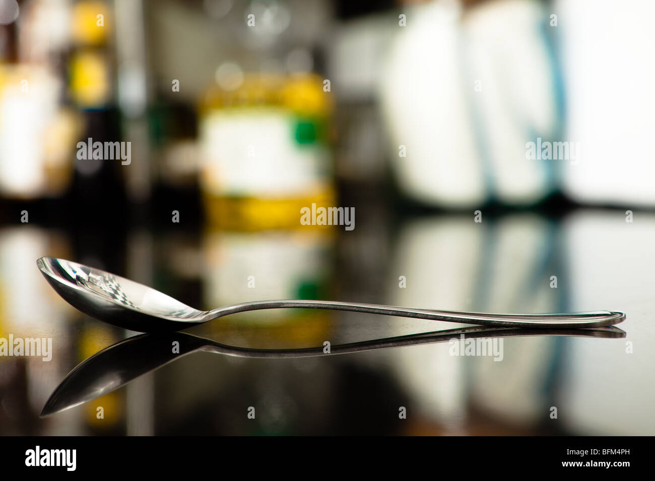Old and Scratchy Spoon with its reflection isolated by shallow depth of ...