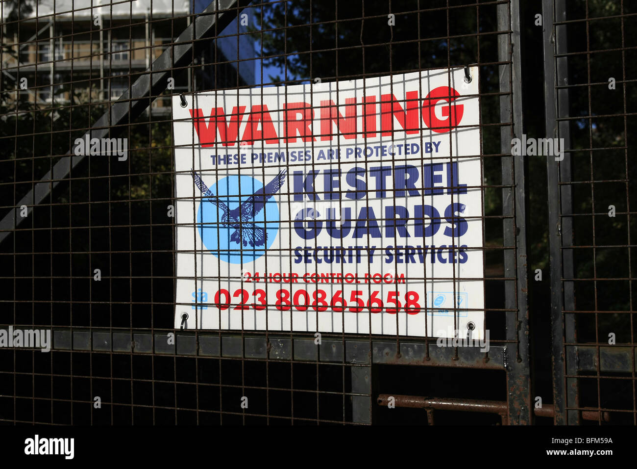 Warning Sign attached to a fence notifying people that the area is ...