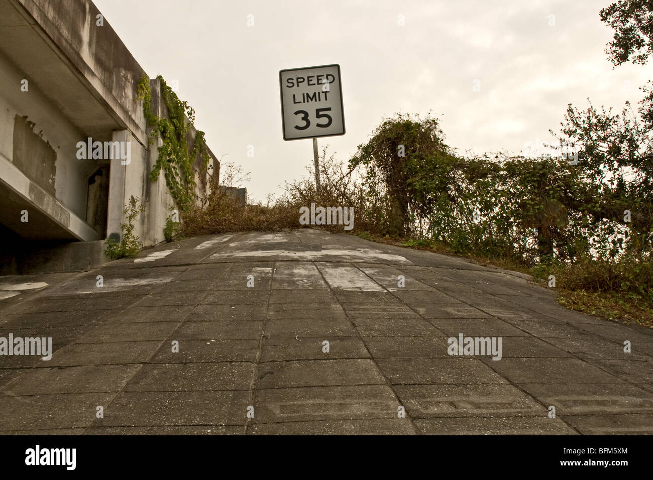 Speed limit sign showing thirty five at the top of a freeway next to a ...