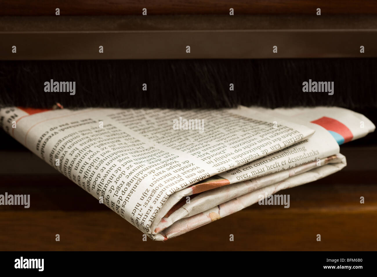 Very high resolution close-up shot of newspaper coming in the mail box ...