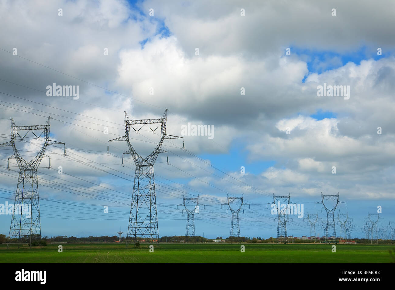 Field full of pylons under blue sky with little clouds Stock Photo - Alamy