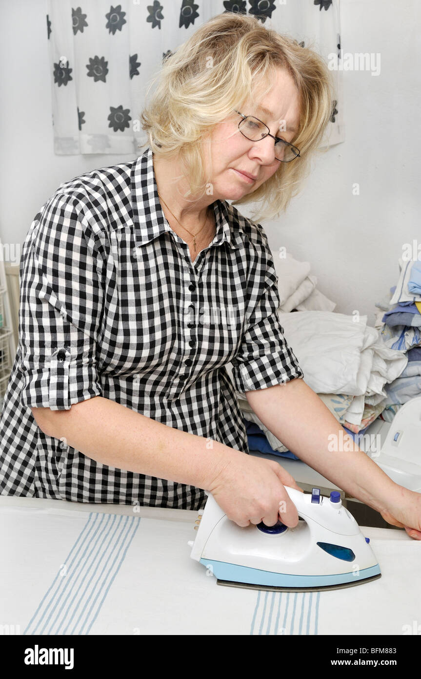 Woman ironing a cloth Stock Photo - Alamy