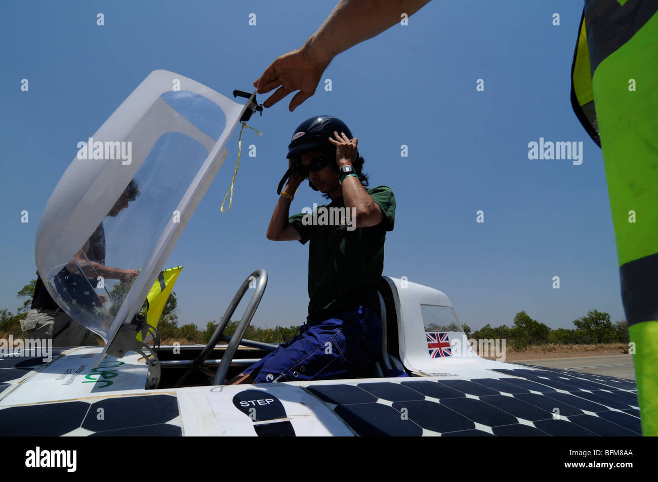 Pilot of a solar racing car removing his helmet Stock Photo - Alamy