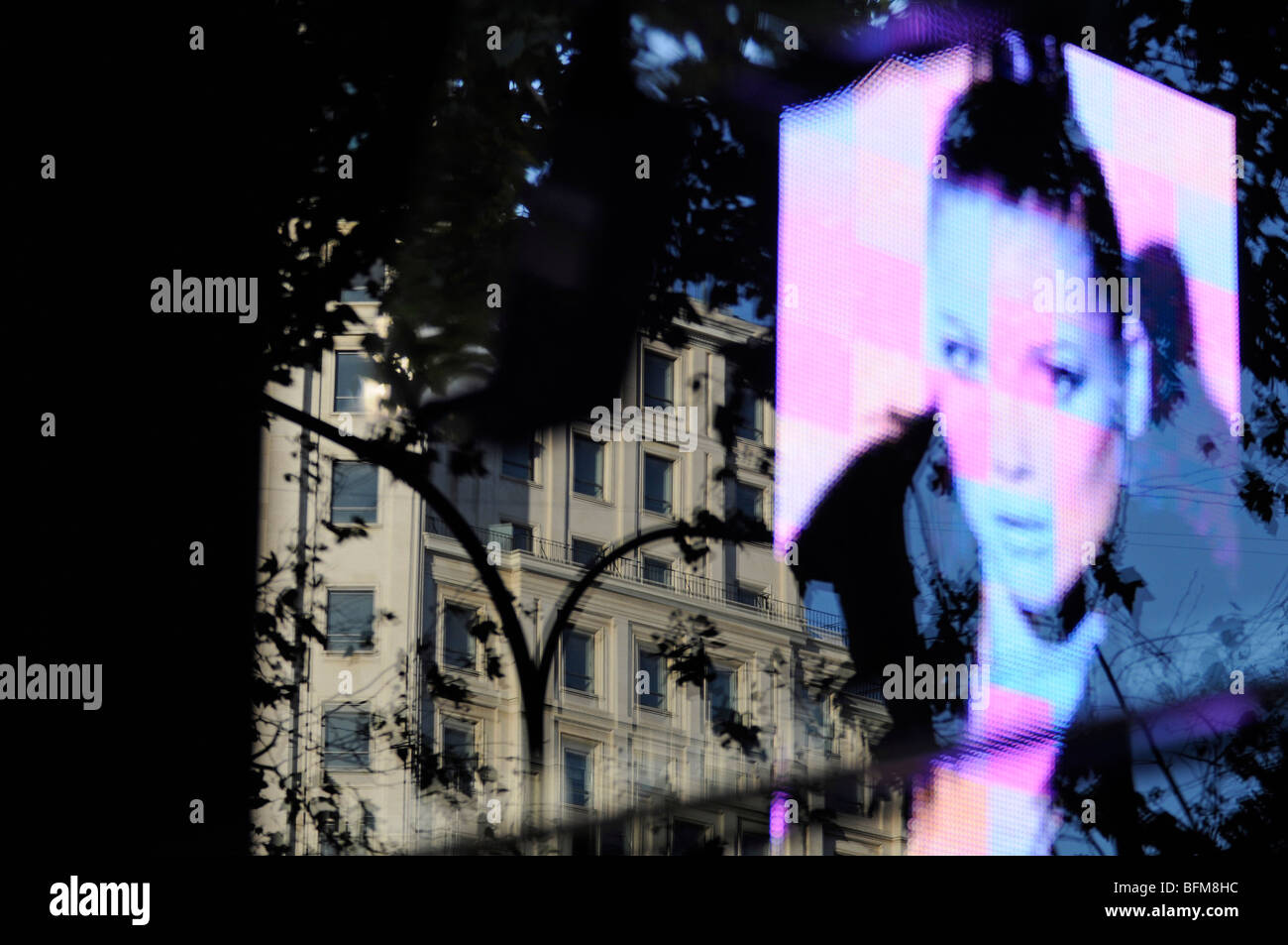 Female supermodel reflected in a fashion clothes shop in Barcelona ...