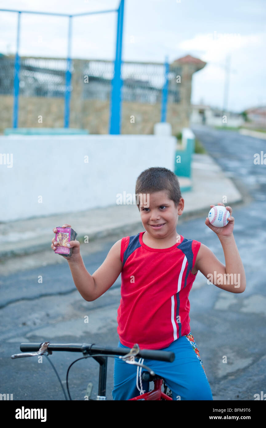 Cuban boy shows off baseball cards and baseball Stock Photo - Alamy