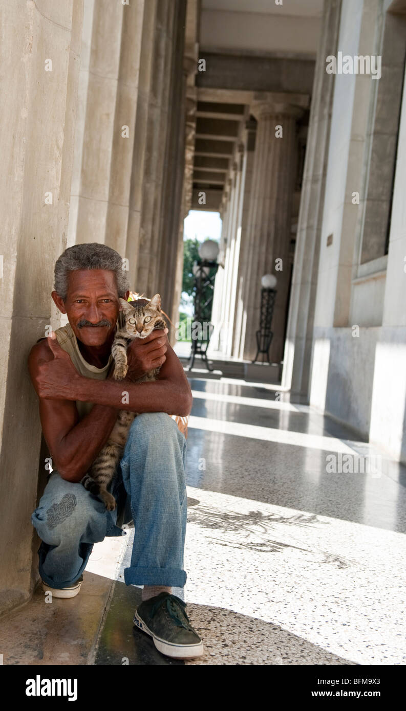 Cienfuegos cemetery worker with his pet cat Stock Photo - Alamy