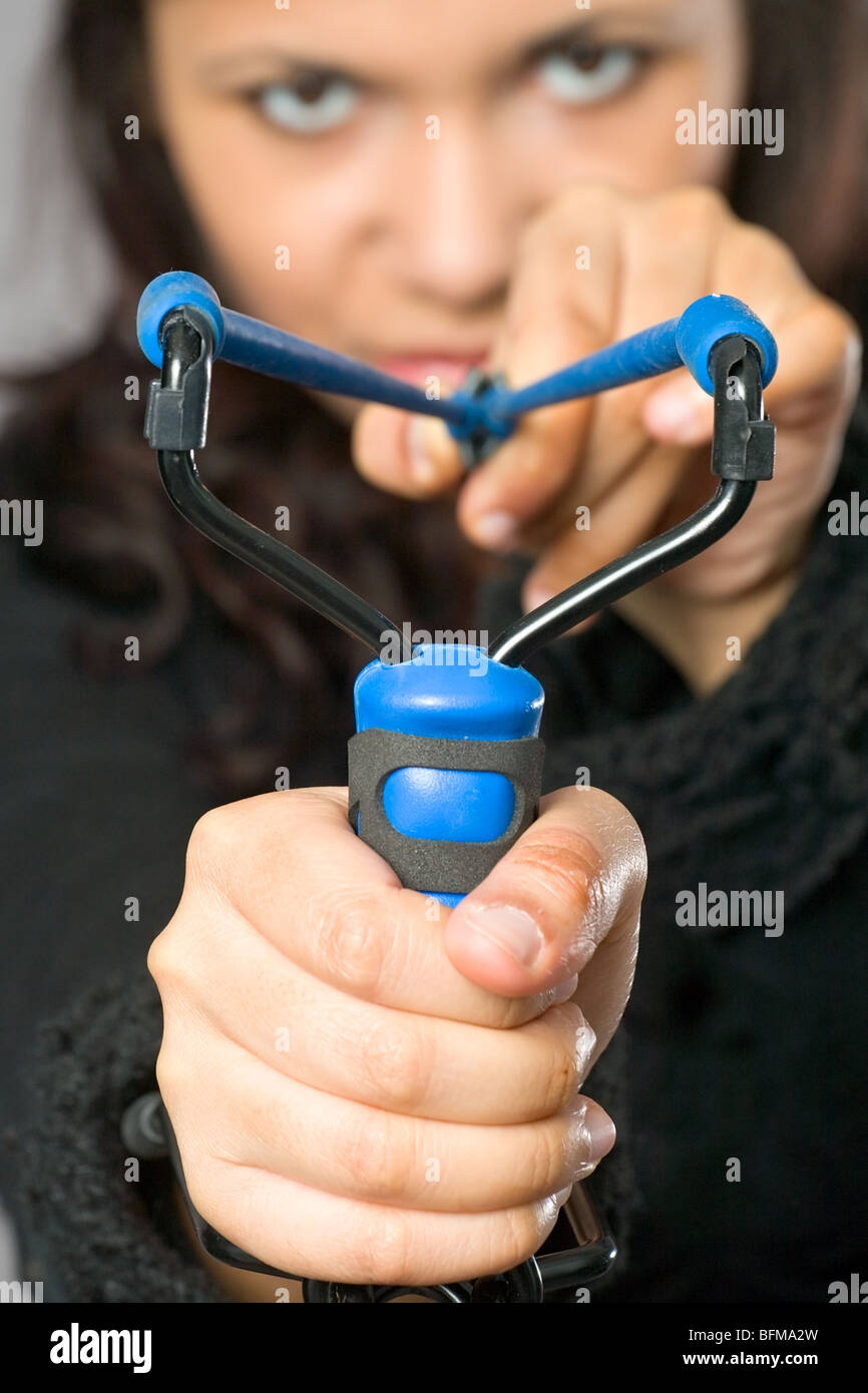 beautiful woman shoots from blue plastic slingshot Stock Photo - Alamy