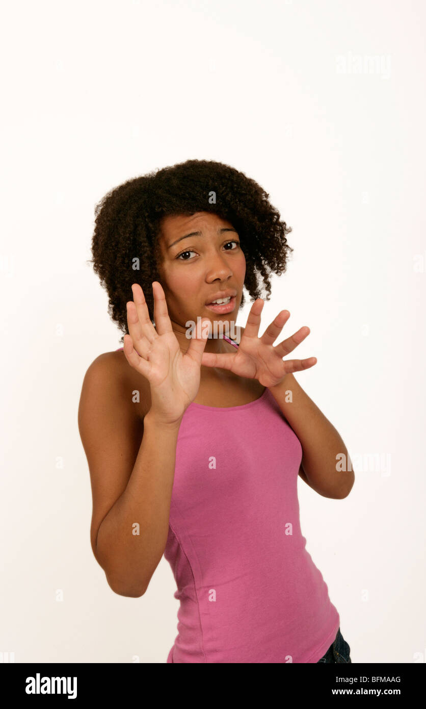 young female with an expression or look of fear. Her hands up to ...