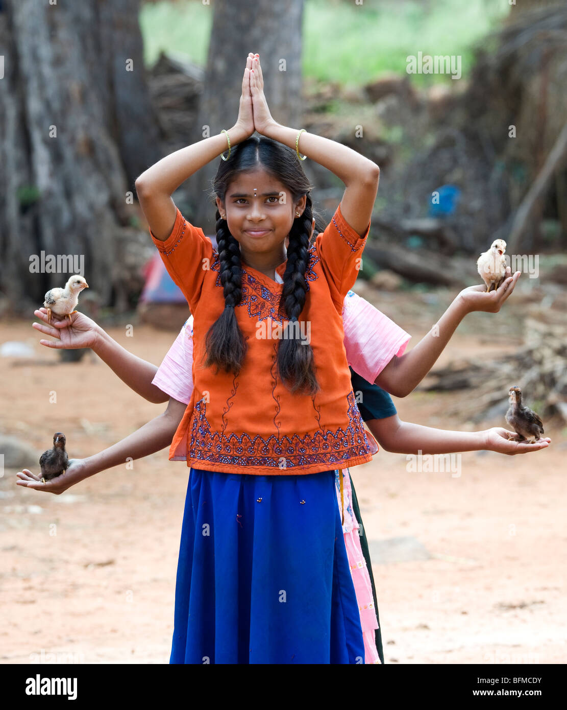 Young indian girls with chicks in the palm of their hands in classical ...