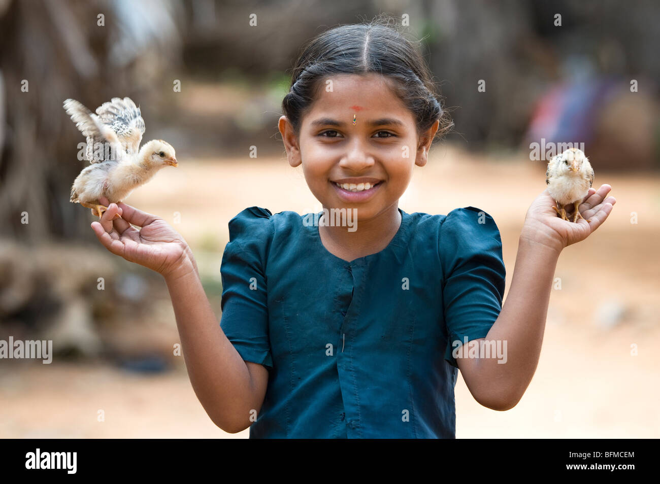 Young indian girl with chicks in the palm of her hands. Nallaguttapalli ...