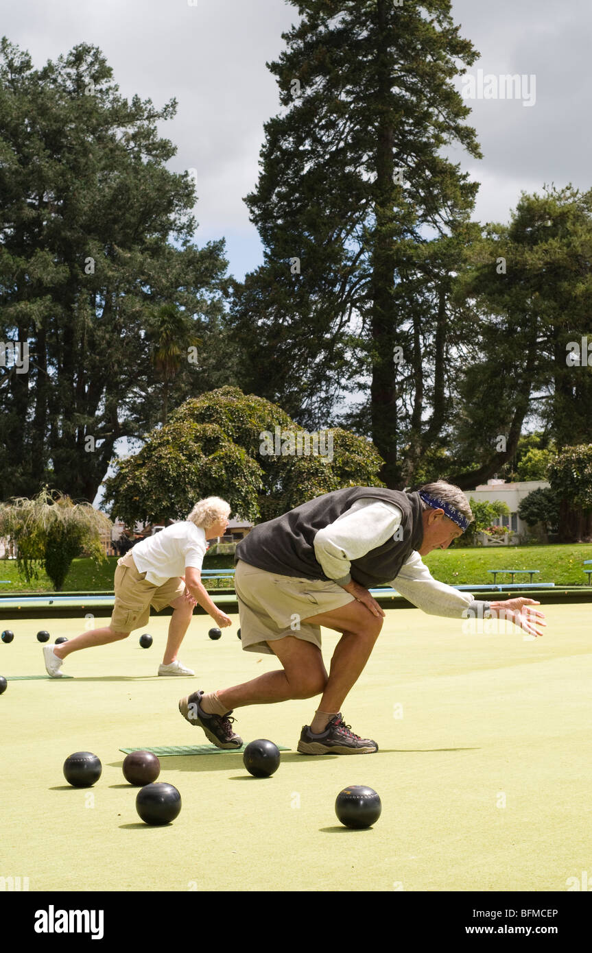 Group of senior adults playing green bowling, at Cambridge bowling club ...