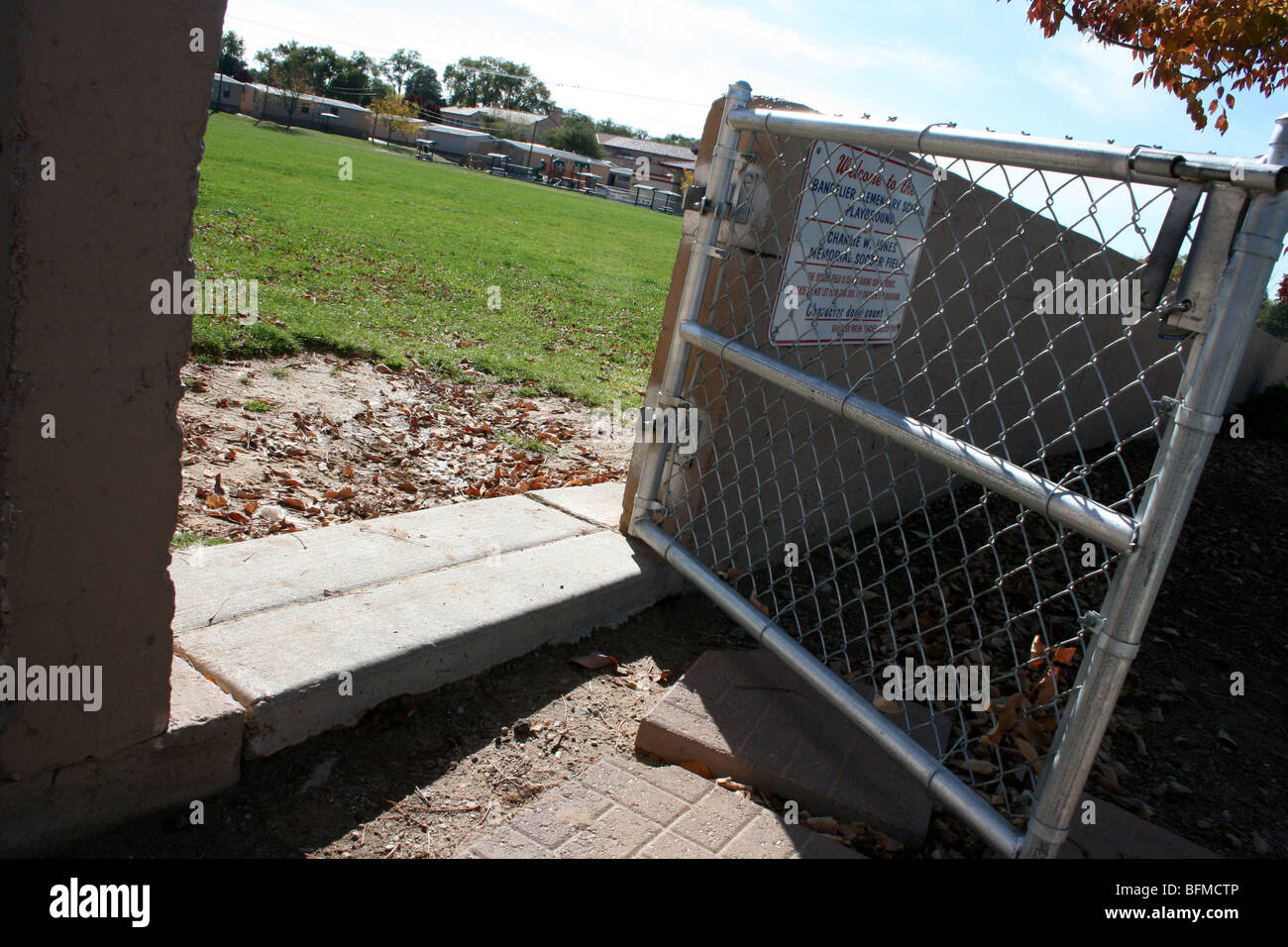 gate left open, leading to a park and school Stock Photo - Alamy