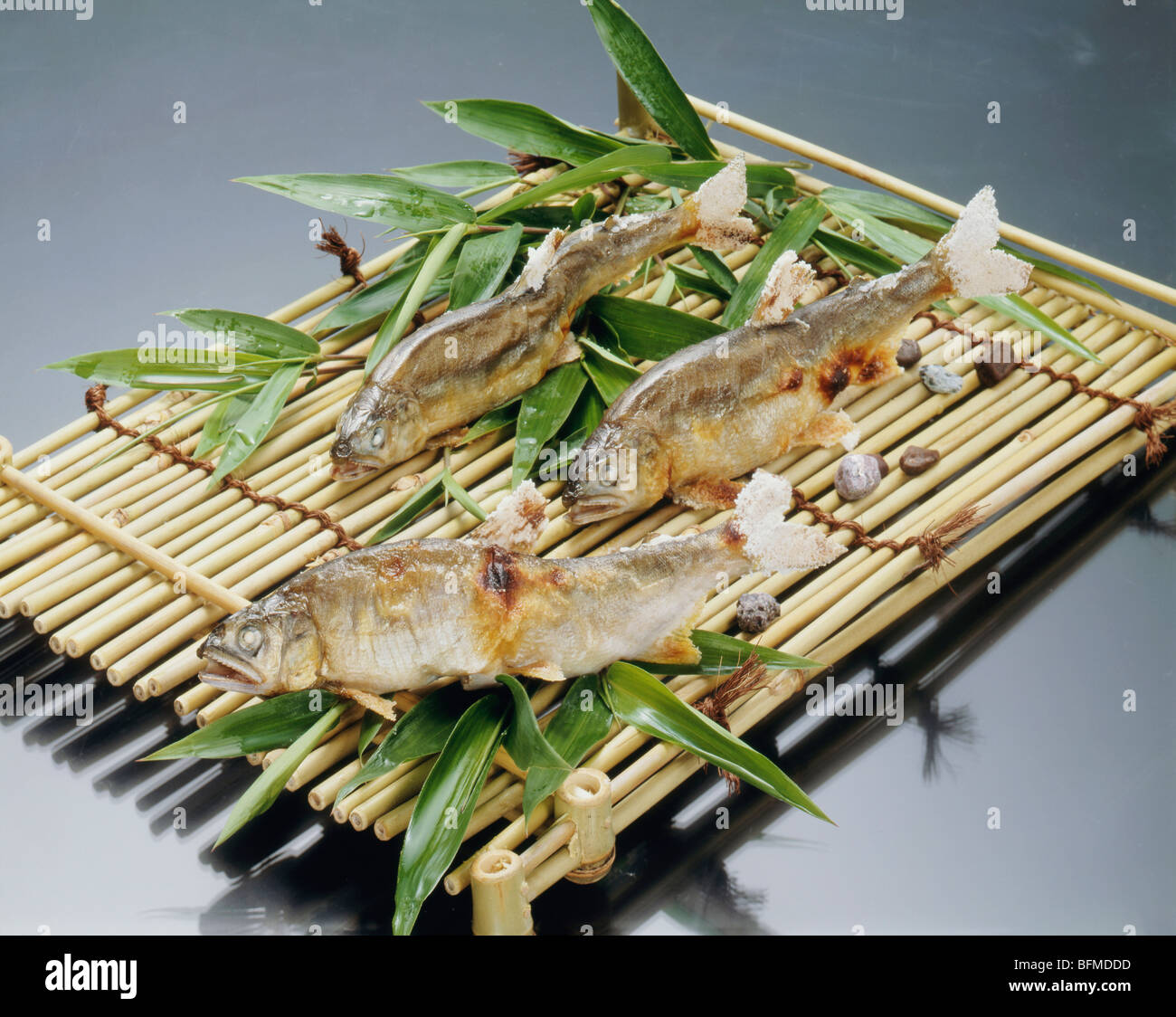 Grilled fish on bamboo tray, black background Stock Photo - Alamy