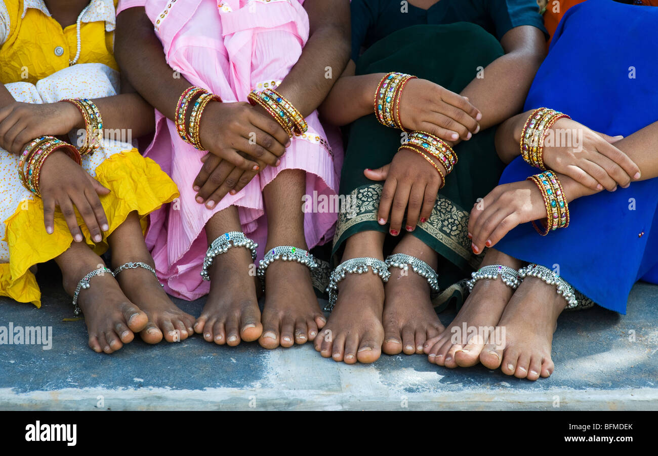 Four Indian girls legs, arms and feet with ankle bracelets and glass ...