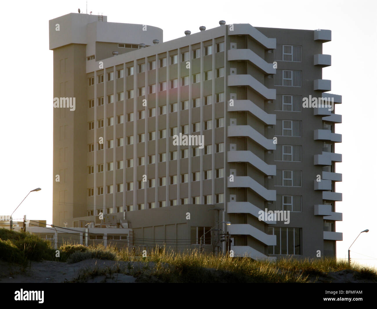 Big building, an hotel, is facing the Ocean and standing up in the ...
