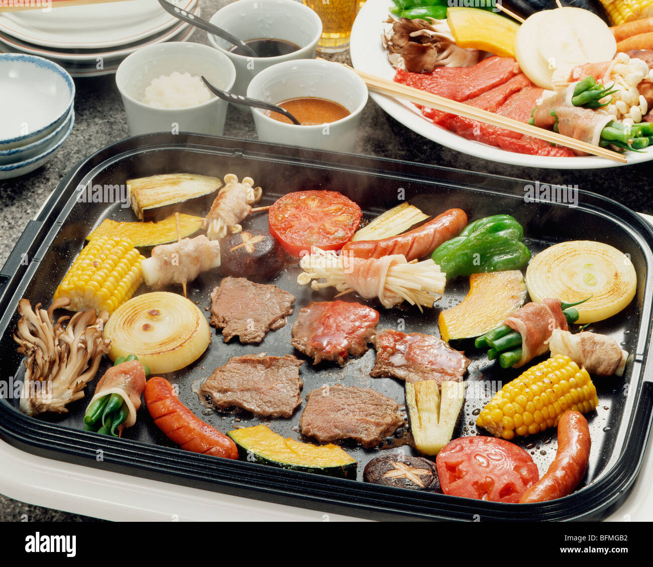 Vegetables and meat grilled on hot plate Stock Photo - Alamy
