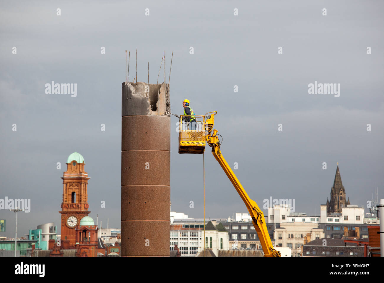 Workman drilling cooling tower from crane during demolition on Booth ...
