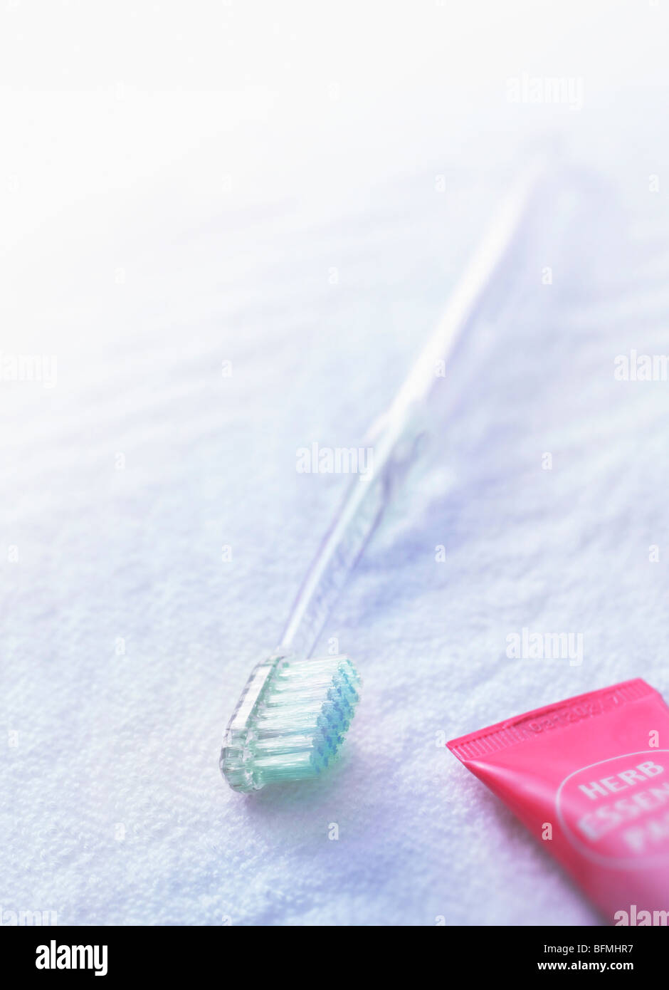 Toothbrush and toothpaste on towel Stock Photo - Alamy