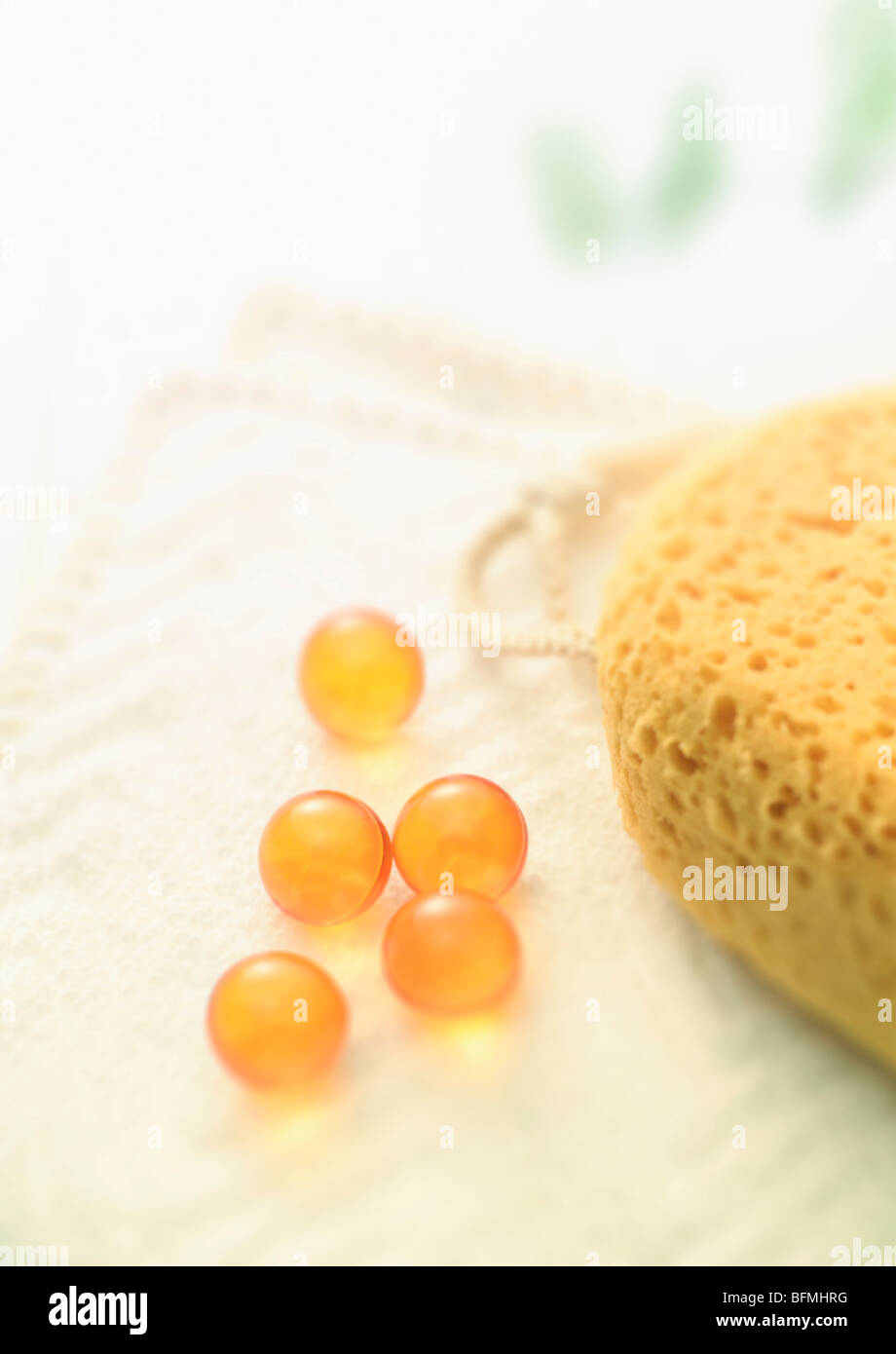 Bath sponge, bath beads and towel Stock Photo - Alamy