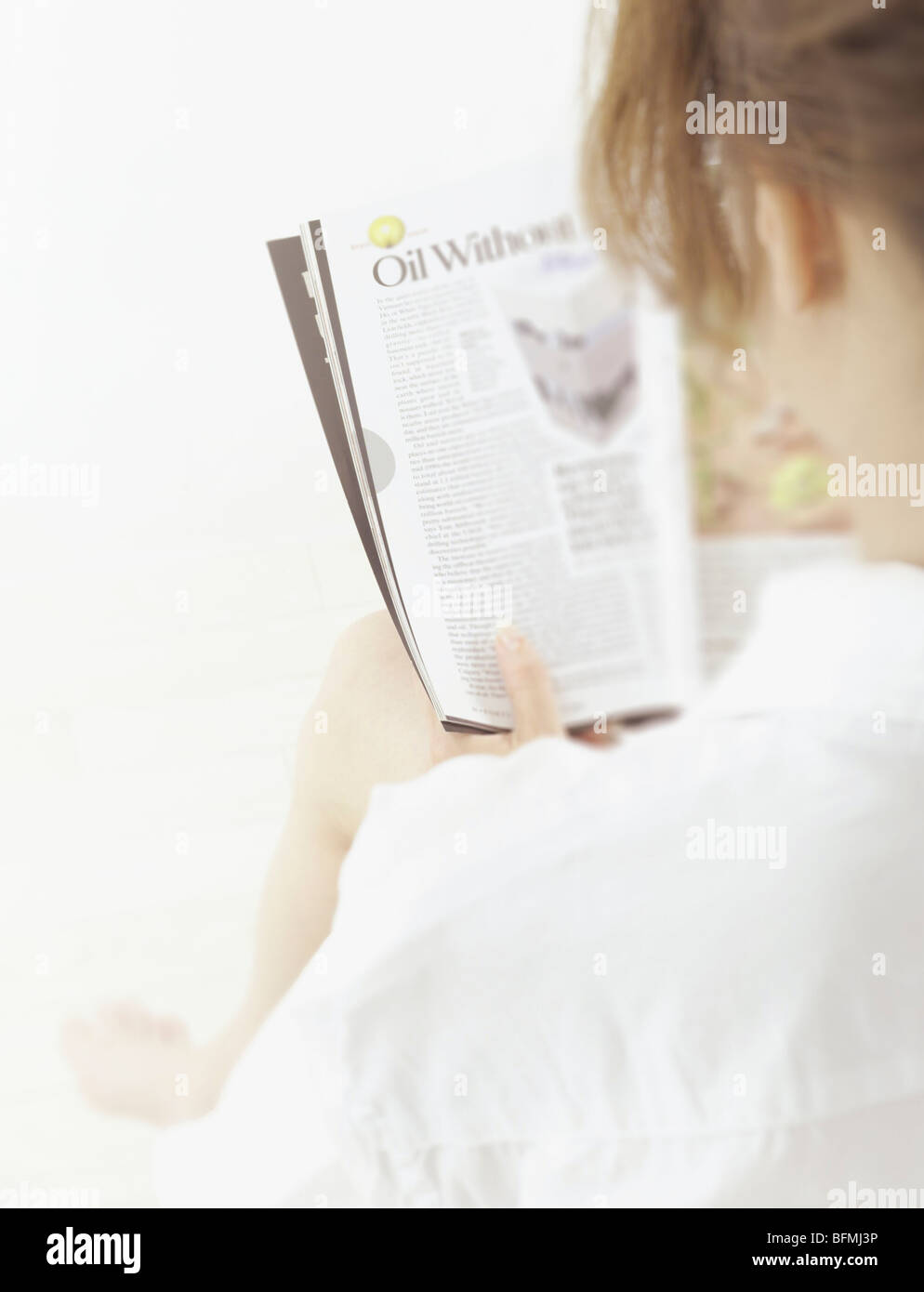Woman reading a magazine Stock Photo - Alamy