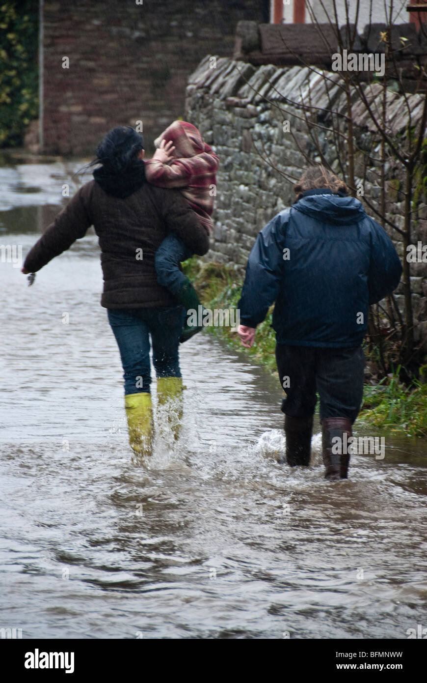 Family wading through flood water at Eamont Bridge, Cumbria Stock Photo ...