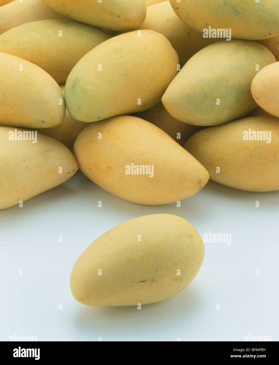 Stack of mangos, white background Stock Photo - Alamy