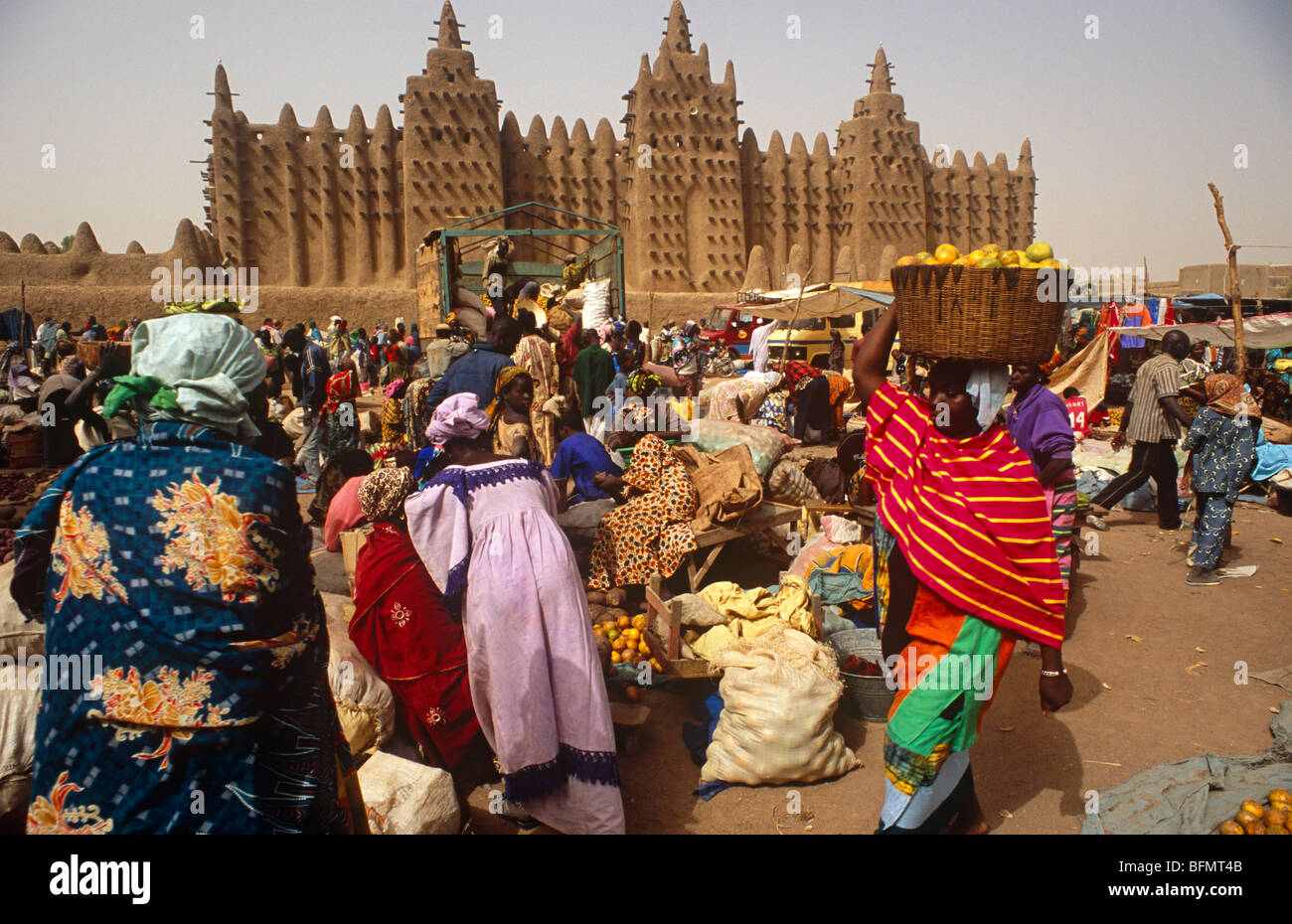 Mali, Djenne. A busy market conducted in front of the Mosque of Djenne ...