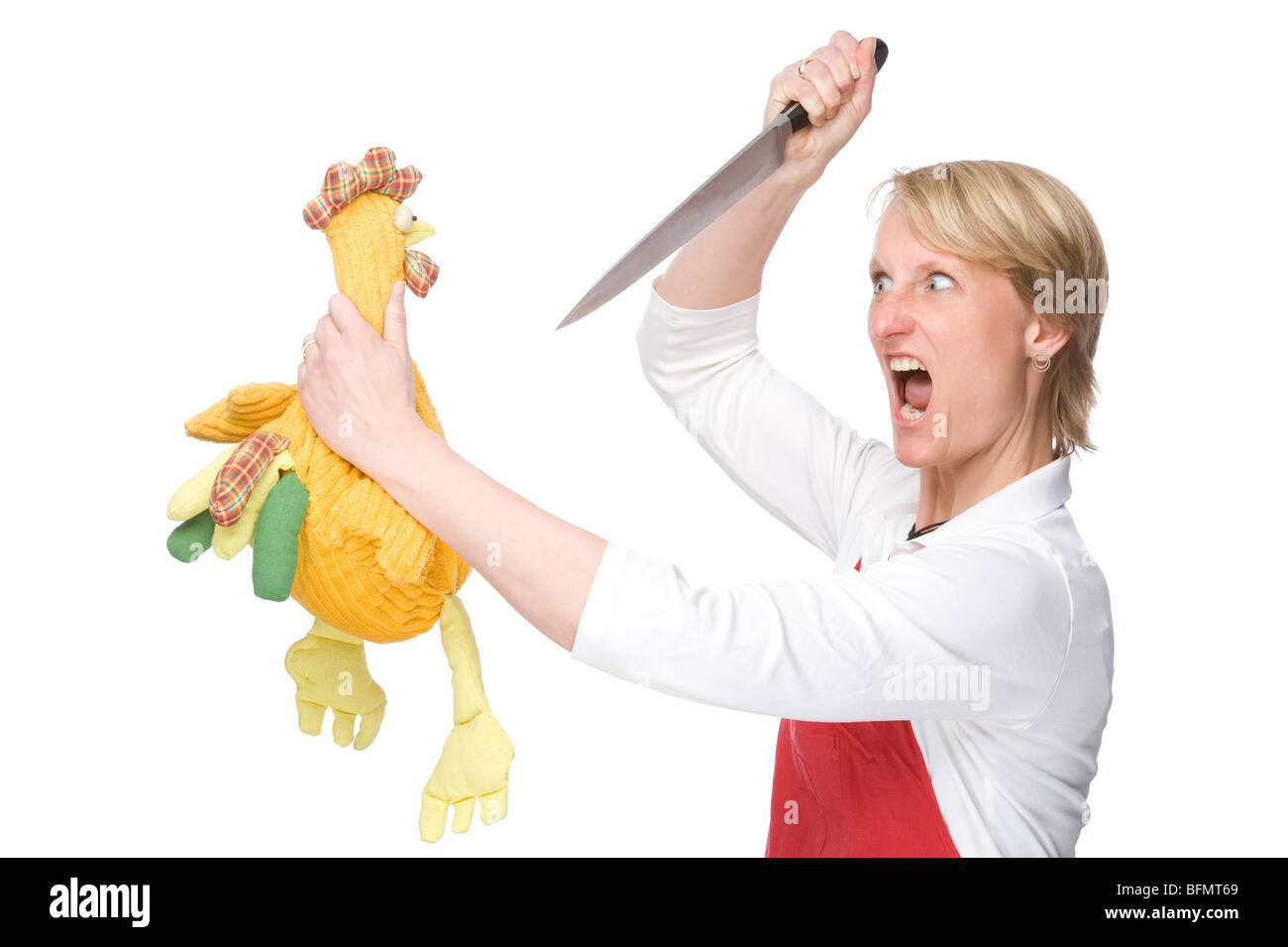 Full isolated studio picture from a young cook with knife and chicken ...