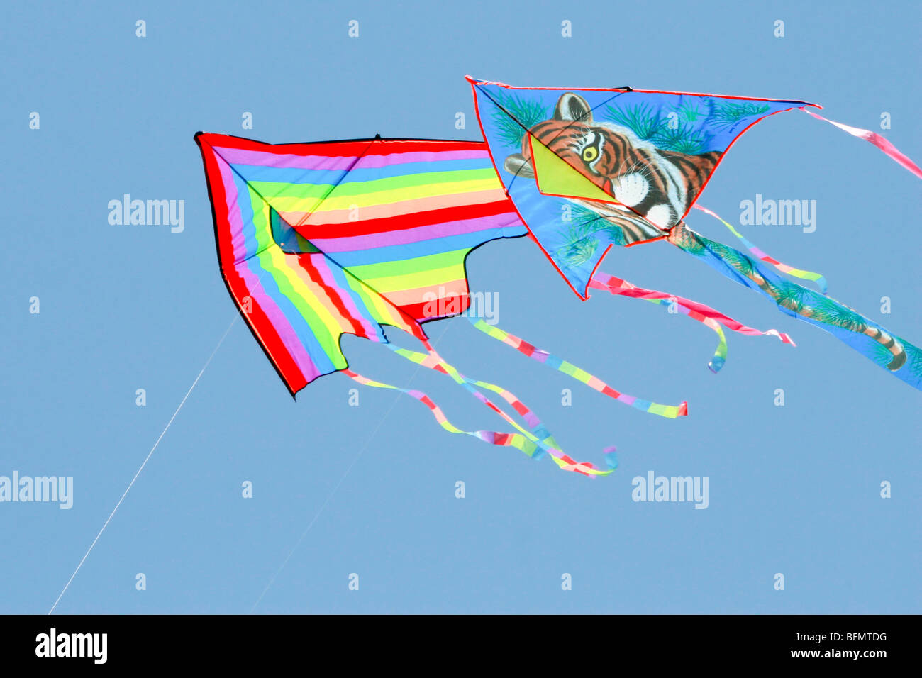 2 kites flying in a blue sky Stock Photo - Alamy