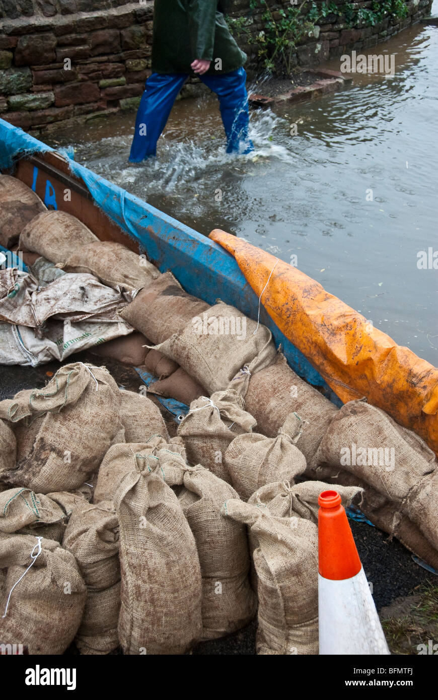 Sand bags protect a house from rising river flood on the River Eamont ...