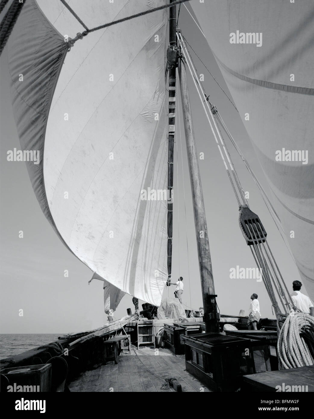 Oman. On the deck of a traditional Kotiya dhow with the sails full ...